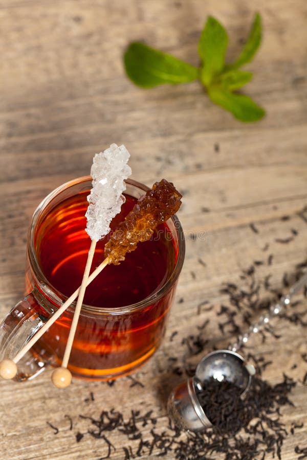 Tea with Candy Brown Sugar on a Sticks Stock Photo - Image of black ...