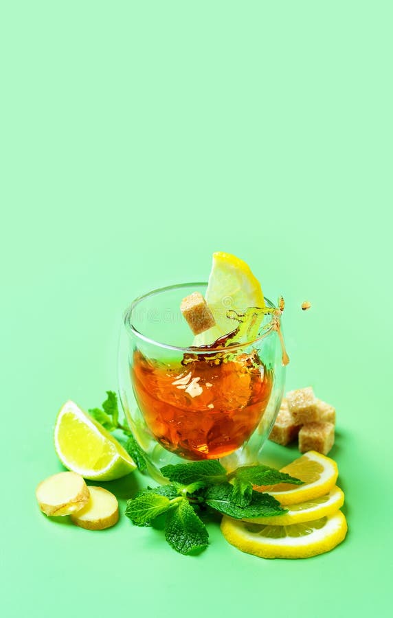 Tea Composition with a Falling Slice of Lemon and Cane Sugar Cube into ...
