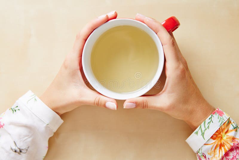 Tea in a cup from above stock photo. Image of hands, thirst - 33696390