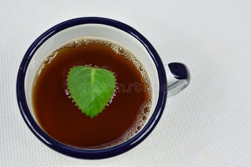 Tea cup with green leaflet stock image. Image of healthy - 158498421
