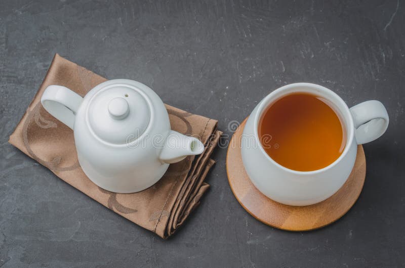 Tea. Cup of Tea and Teapot. White Ware on a Black Stone Table Stock ...