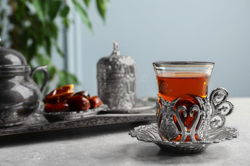 Tea and Date Fruits Served in Vintage Tea Set on Grey Table, Space for ...