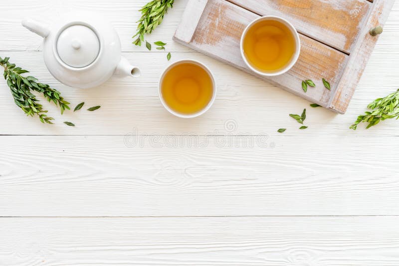 Tea Drinking with White Teapot and Two Cups with Green Leaves, Top View ...