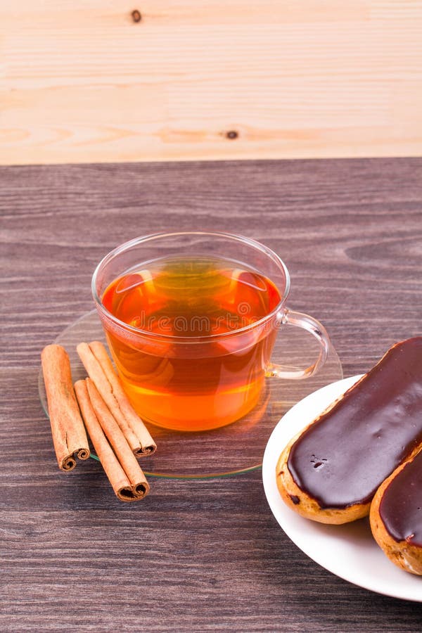 Tea, eclairs and cinnamon stock photo. Image of fresh - 67787658