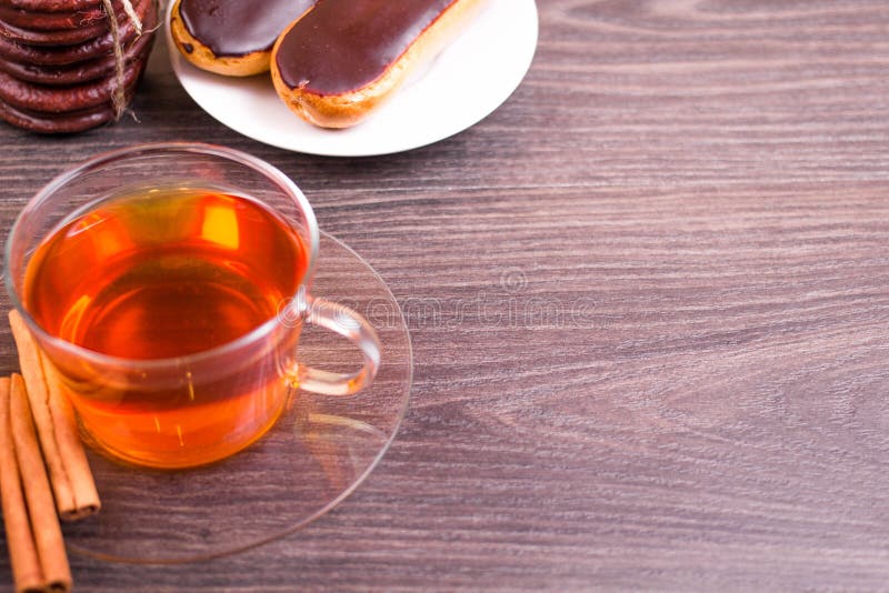Tea, eclairs and cinnamon stock image. Image of culture - 67787679