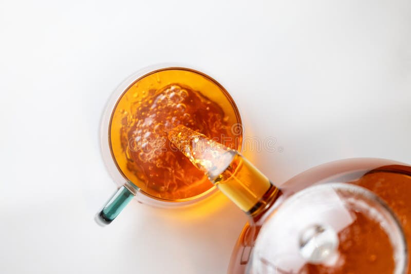 Tea Flowing To a Glass Cup from a Glass Teapot, Top View Stock Image ...