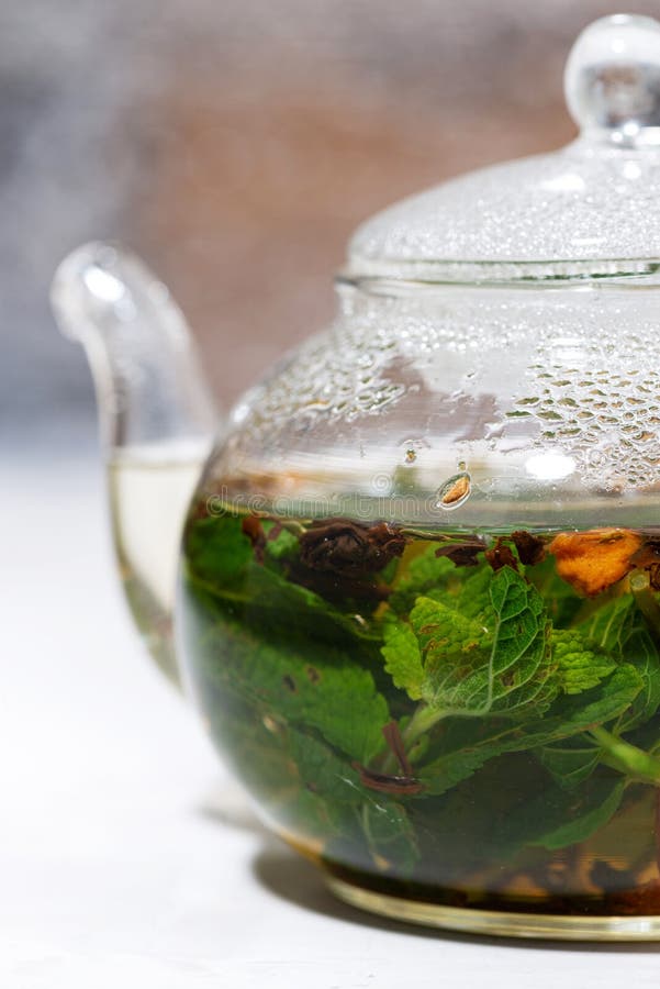 Tea with Fresh Mint and Lemon in a Glass Teapot, Vertical Closeup Stock ...