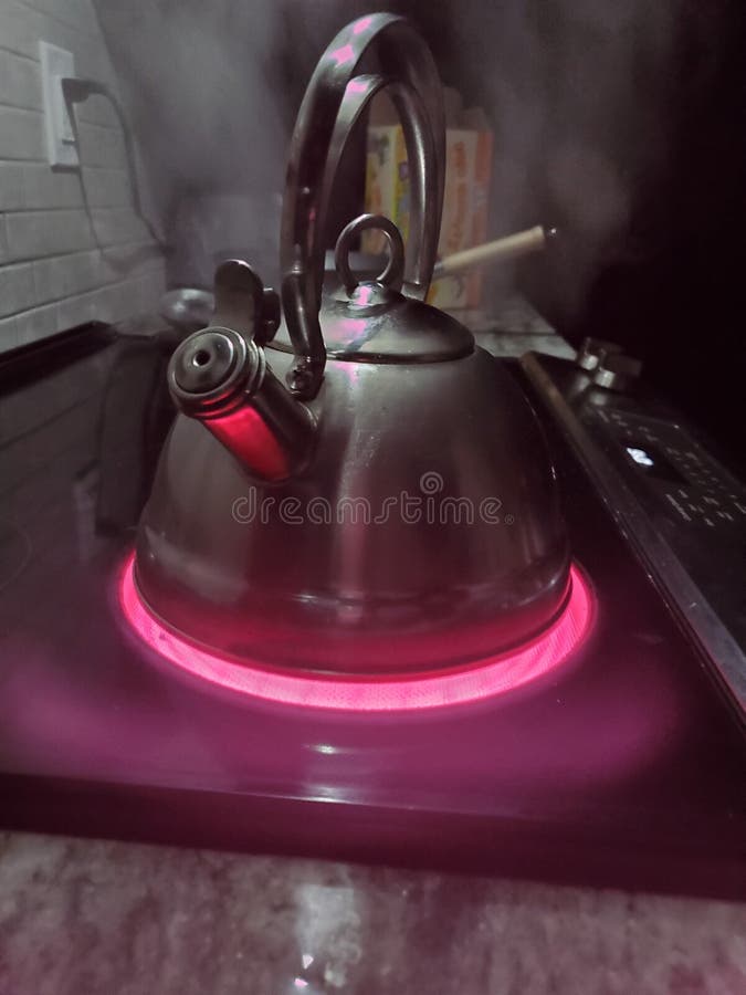 Tea Kettle with Steam Over a Hot Gas Stove Stock Photo - Image of ...