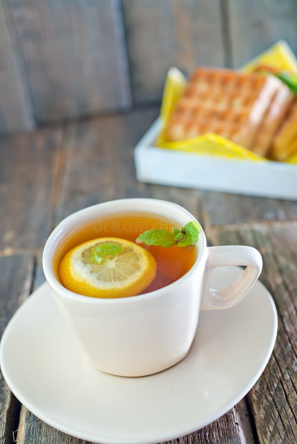Tea with lemon and waffle stock photo. Image of drink - 51454840