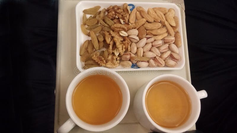 Tea and nuts stock image. Image of sweets, plate, nuts - 99756897
