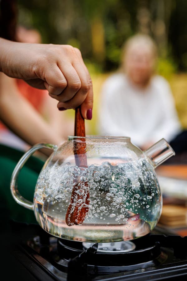 A Tea Master Stirs Boiling Water in a Transparent Teapot Stock Photo ...