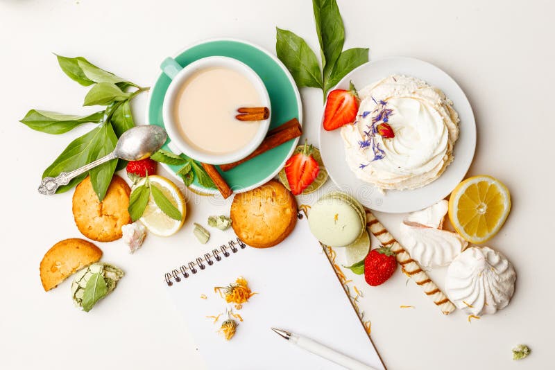 Tea with Milk on the Table with Sweets, Strawberries and Lemons Stock ...