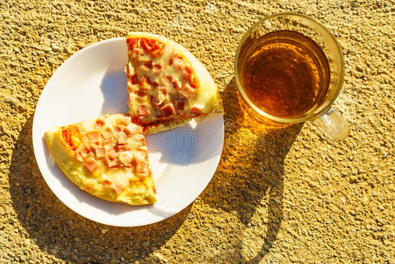 Tea Mug and Pizza Slices on Plate, Outdoors Stock Photo - Image of ...