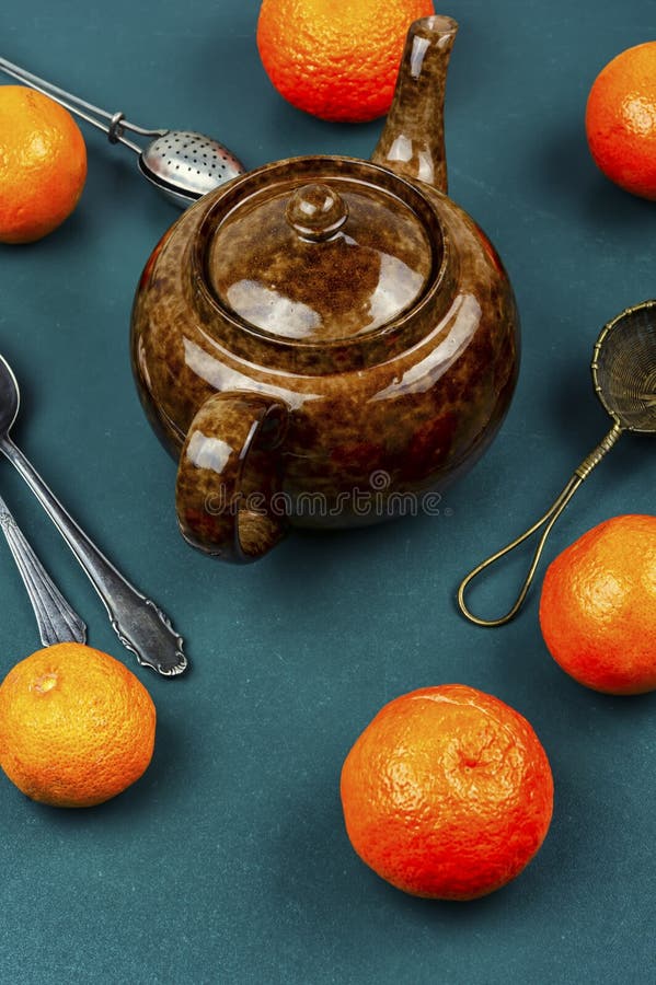 Tea pot with clementines stock image. Image of beverage - 355754389