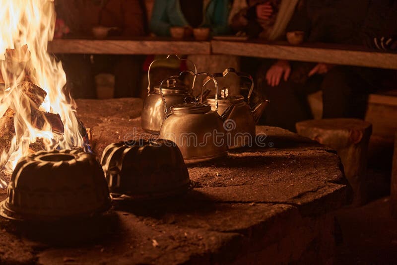 Tea Pots by the Fire in a Hut Stock Photo - Image of wooden, light ...