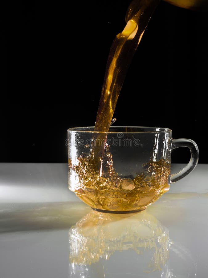 Tea is Poured into a Cup with a Splash Stock Image - Image of ...