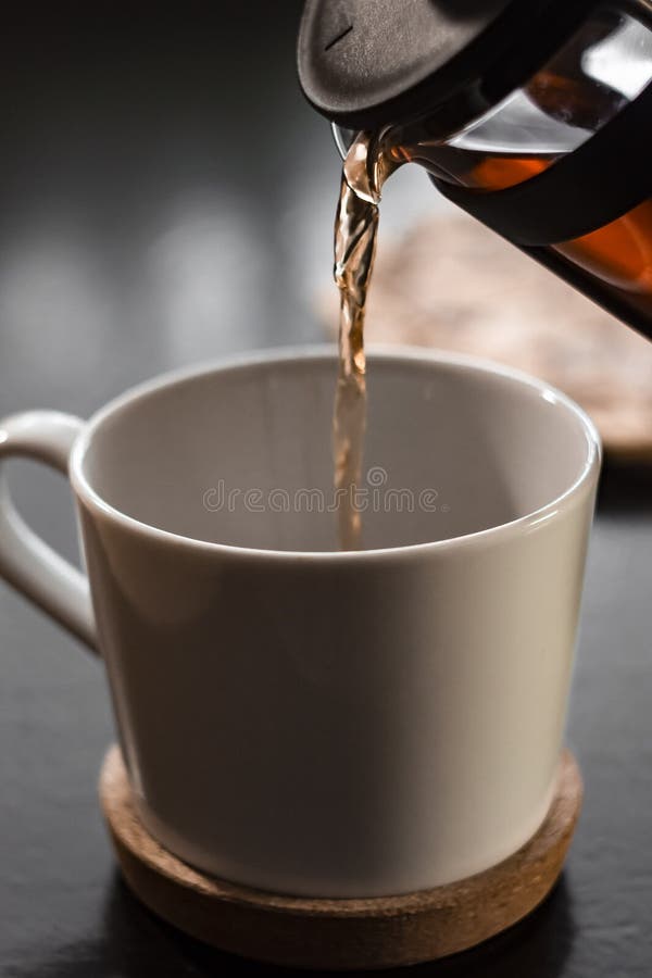Tea is Poured into a White Cup. Tea Time. Close Up Stock Image - Image ...