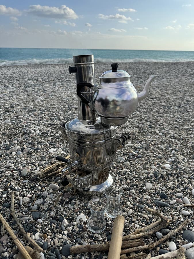 Tea Preparation on a Beach with a Unique Kettle and Samovar Under a ...