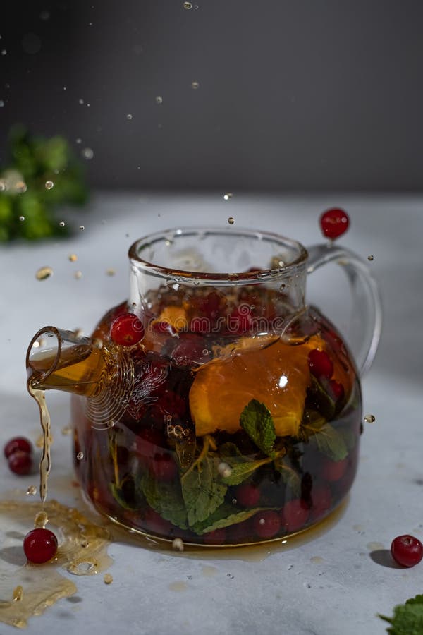 Tea Splash with Citrus, Cranberries and Mint in a Glass Teapot ...