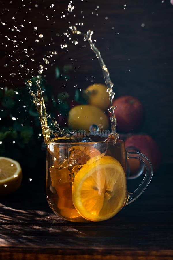 Tea is Splashed Out of a Dissold Mug with Tea Inside and Pieces of ...