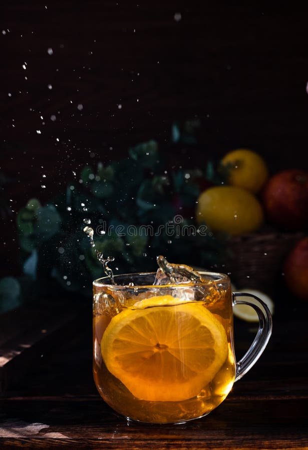 Tea is Splashed Out of a Dissold Mug with Tea Inside and Pieces of ...