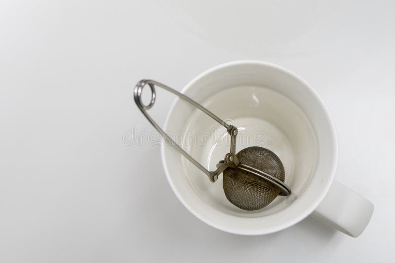 Tea Strainer Spring Mesh Ball Enclosure of Old in the White Cup Stock ...