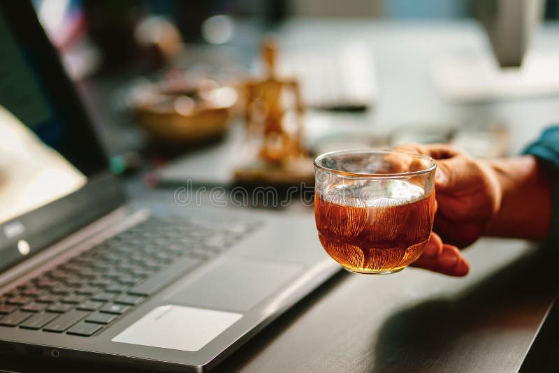 Tea Time Concept .hand Holding Tea Cup on Office Table with Lap Stock ...