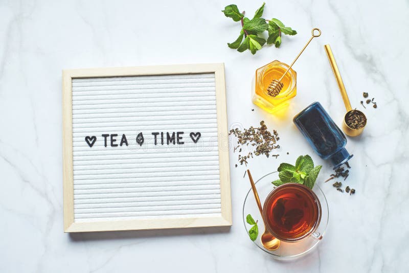 Tea Time. White Letter Board with Text on Marble Table with Glass Cup ...