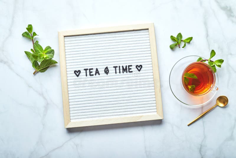 Tea Time. White Letter Board with Text on Marble Table with Glass Cup ...