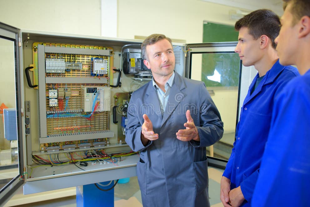 Teacher and Apprentice at Panel Board Stock Image - Image of uniform ...