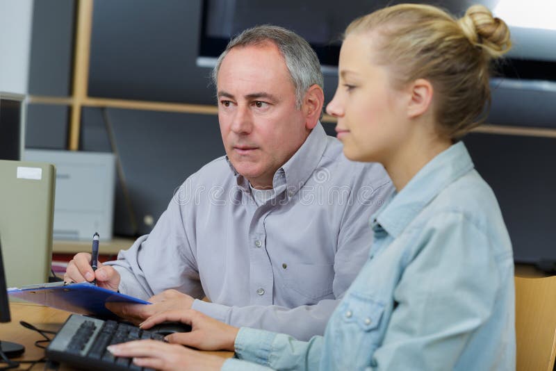 Teacher Assessing Student Using Computer Stock Image - Image of ...
