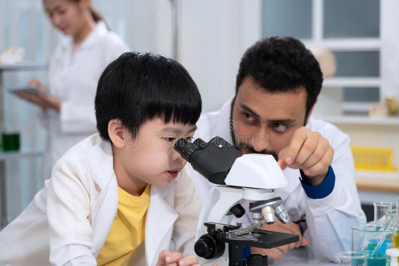 Teacher with Beard and Student Wearing White Laboratory Coat in ...