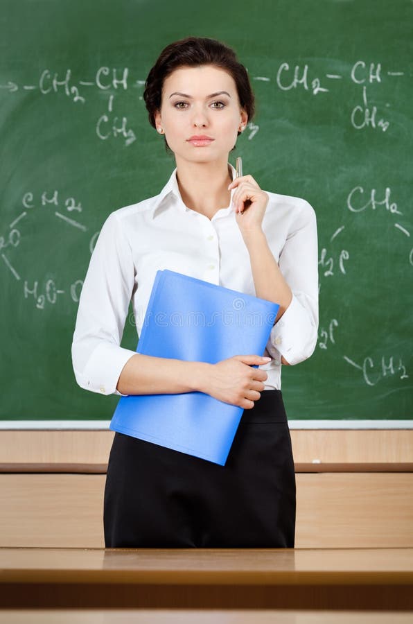 Teacher at the blackboard stock photo. Image of earnest - 26548612