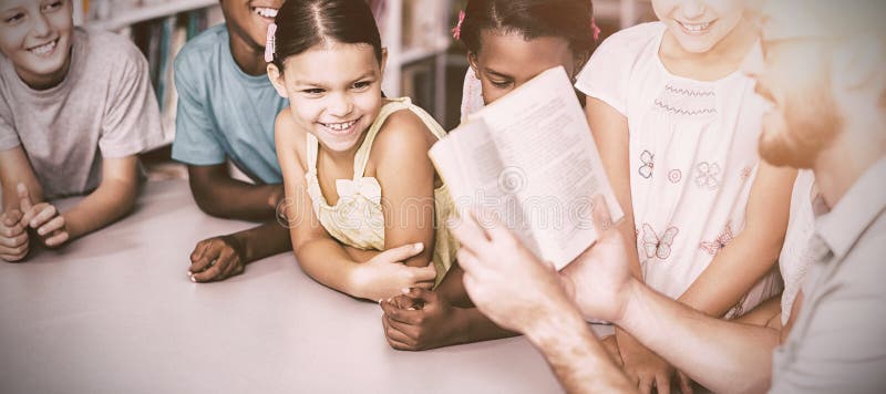 Teacher with Book Teaching Students in Library Stock Image - Image of ...