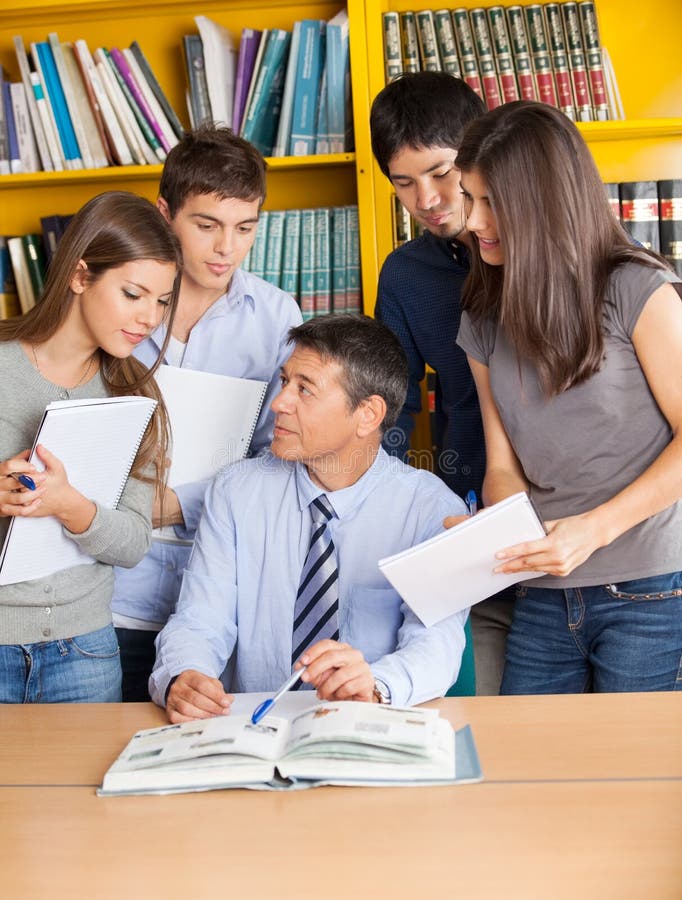 College Teacher Explaining Lesson To Students In Stock Image - Image of ...