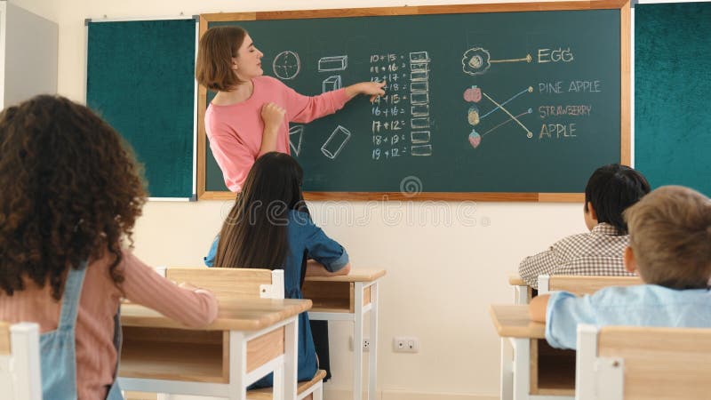 Teacher Checking Cute Student Homework while Explaining Idea at Class ...