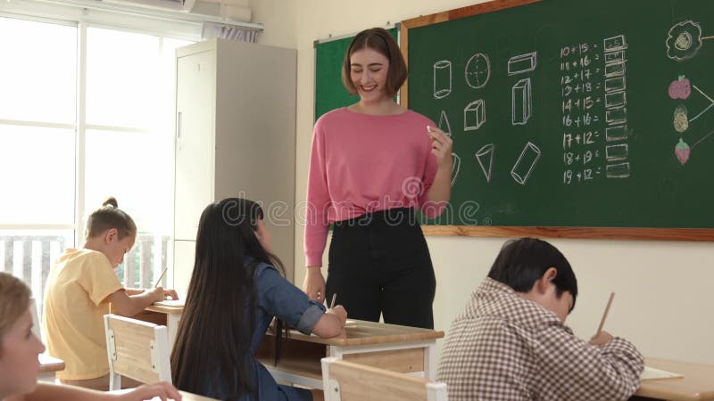 Teacher Checking Cute Student Homework while Explaining Idea at Class ...