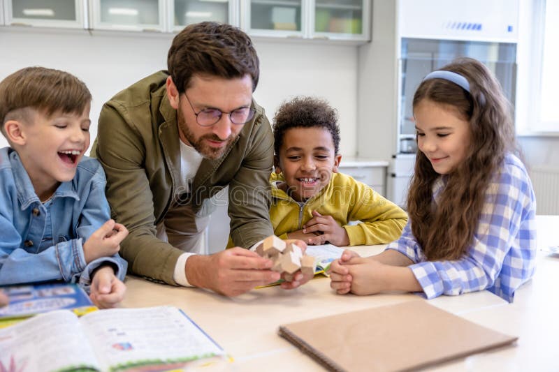 Teacher and Children in a Classroom, Exploring a New Topic in Chemistry ...