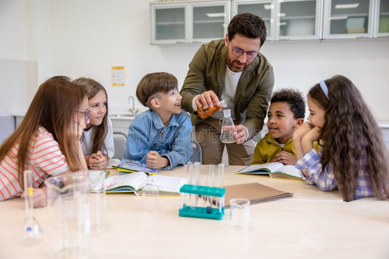 Teacher and Children in a Classroom, Exploring a New Topic in Chemistry ...