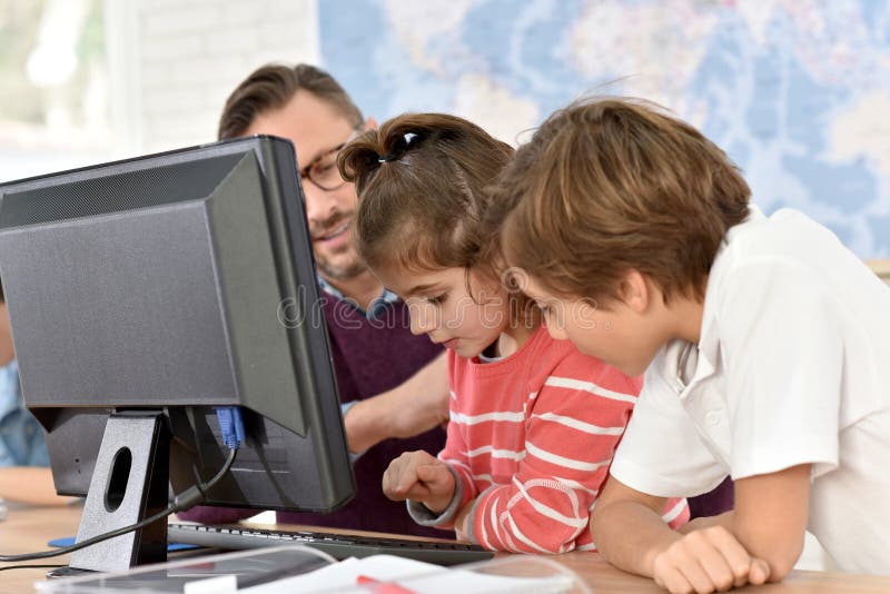 Teacher with Children Working on Computer Stock Image - Image of ...