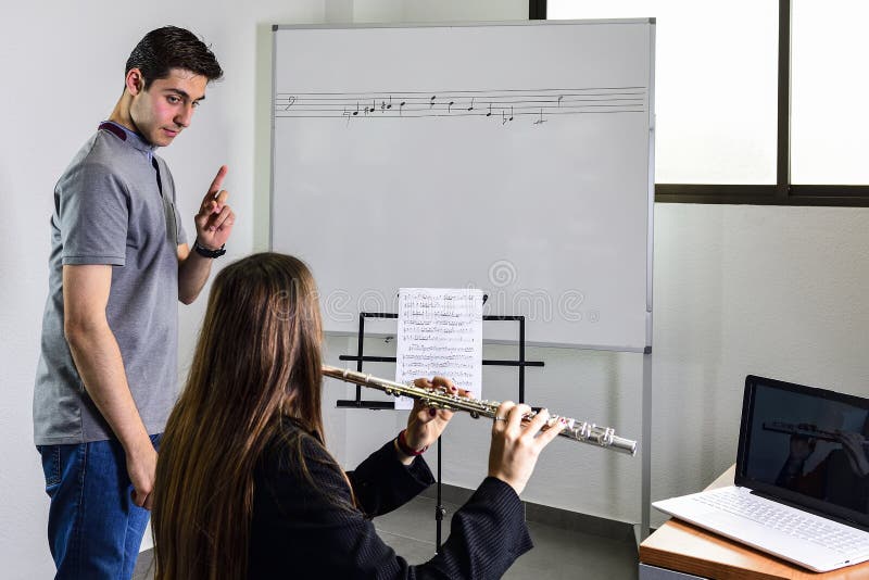 Teacher Corrects Music in the Classroom, To a Young Student Stock Photo ...