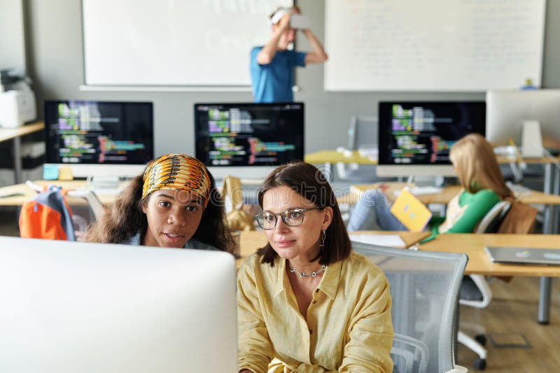 Teacher Working with Students at Lesson Stock Photo - Image of computer ...