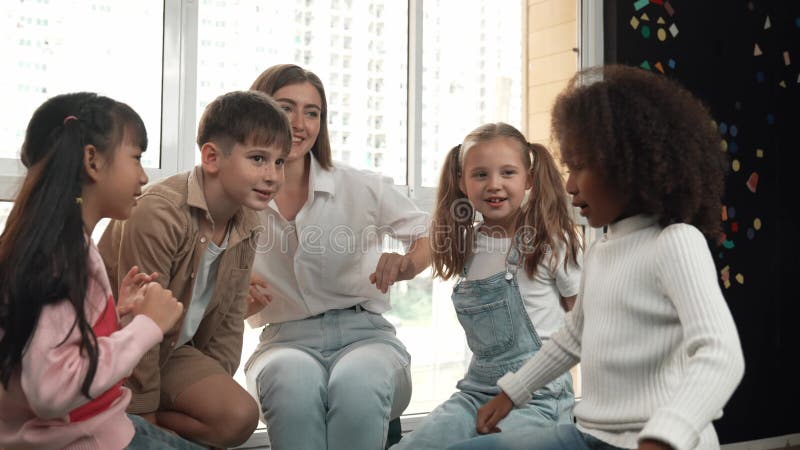 Teacher and Diverse Students Putting Hands Together at Classroom ...