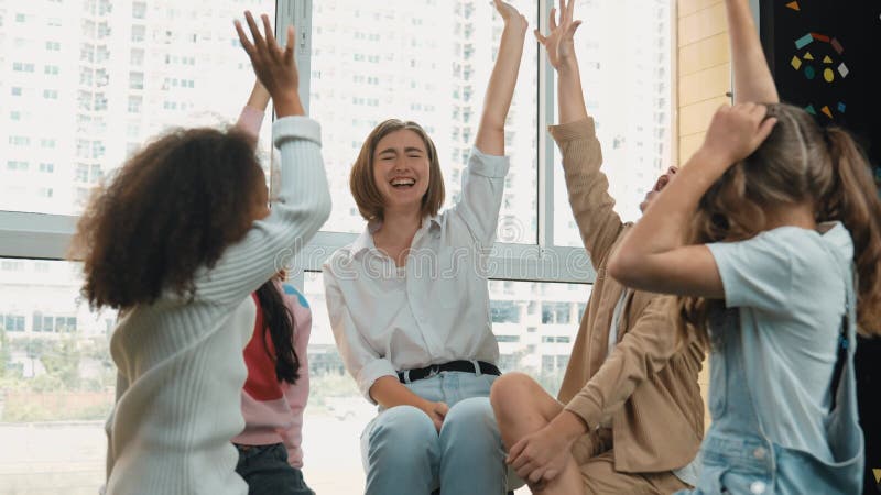 Teacher and Diverse Students Putting Hands Together at Classroom ...