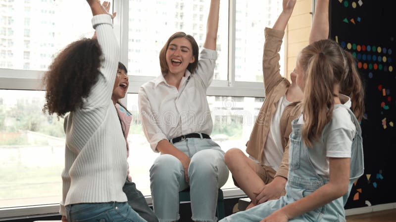 Teacher and Diverse Students Putting Hands Together at Classroom ...