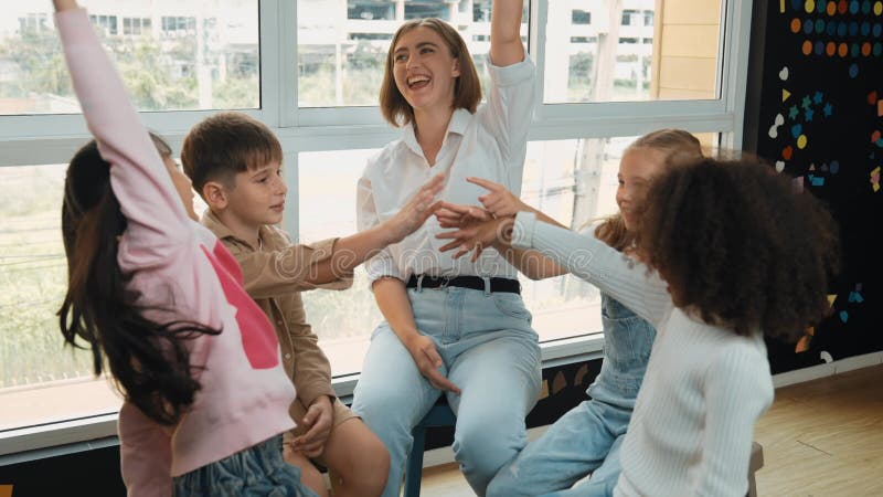 Teacher and Diverse Students Putting Hands Together at Classroom ...
