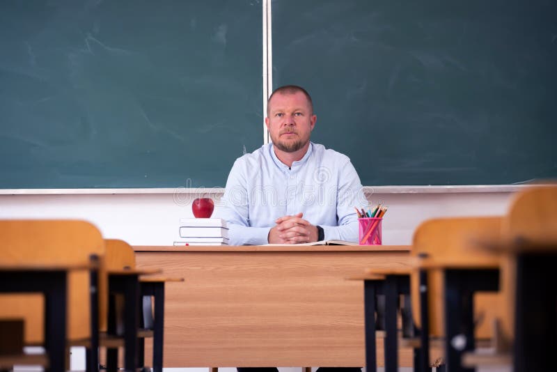 Teacher in empty classroom stock image. Image of cheerful - 229486323