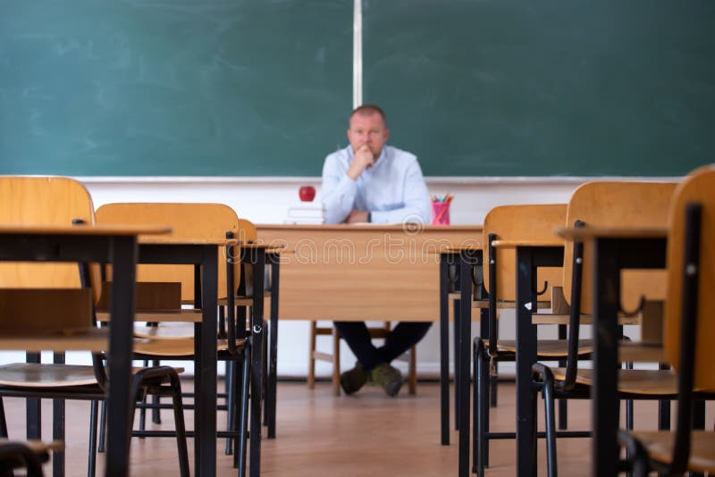 Teacher in empty classroom stock image. Image of cheerful - 229486323