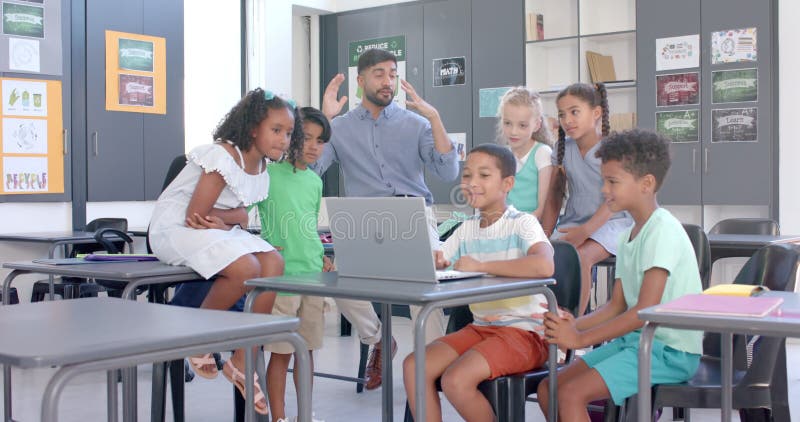 Teacher Engages with Diverse Students in a Classroom Setting in School ...