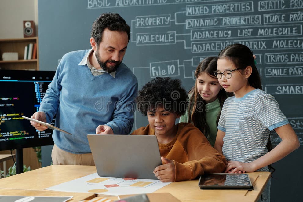 Teacher Engaging Students in Computer Class with Laptops Stock Image ...
